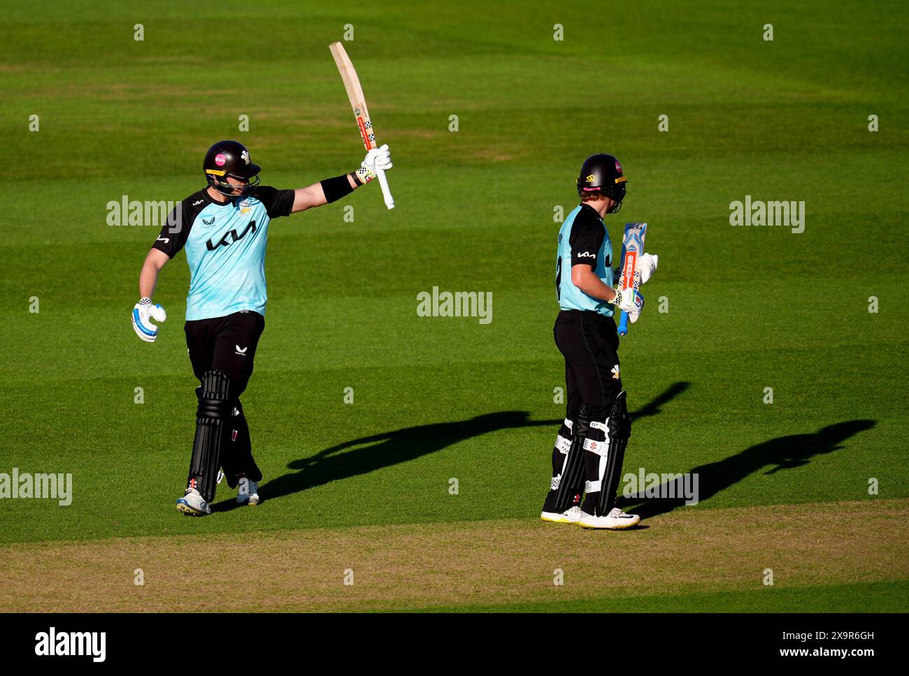 Surrey's Jamie Smith (left) celebrates reaching his half-century during ...