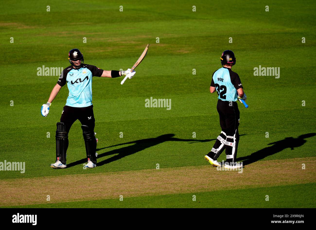 Surrey's Jamie Smith (left) celebrates reaching his half-century during ...