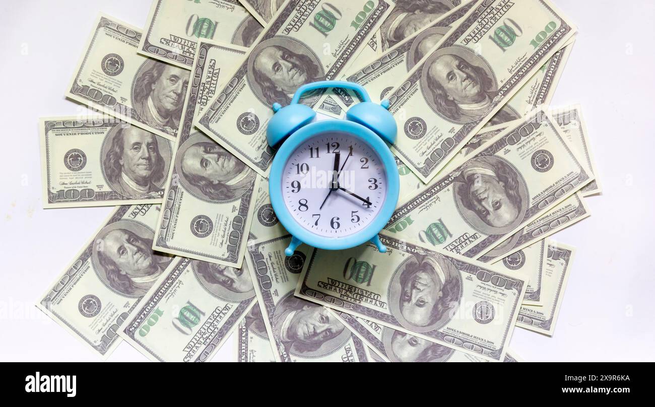 Time - money concept with clock and dollar bills closeup Stock Photo ...