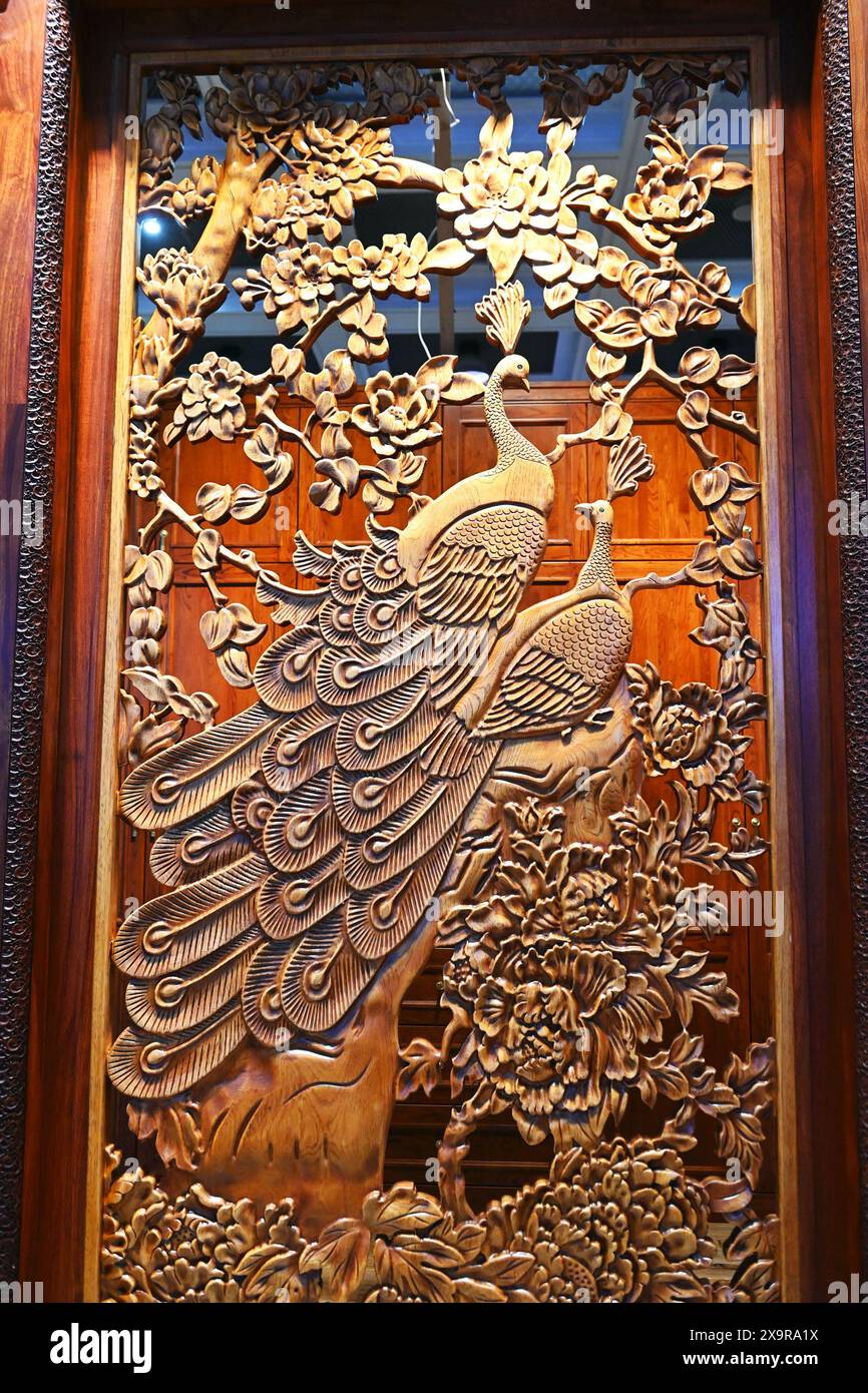 An exhibitor is displaying a cut-out wooden door at the HOME EXPO in Qingdao, China, on June 1 ...