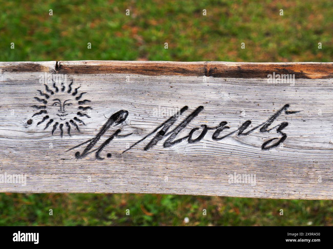 Inscription on bench "St.Moritz" and smiling sun with rays, St.Moritz ...