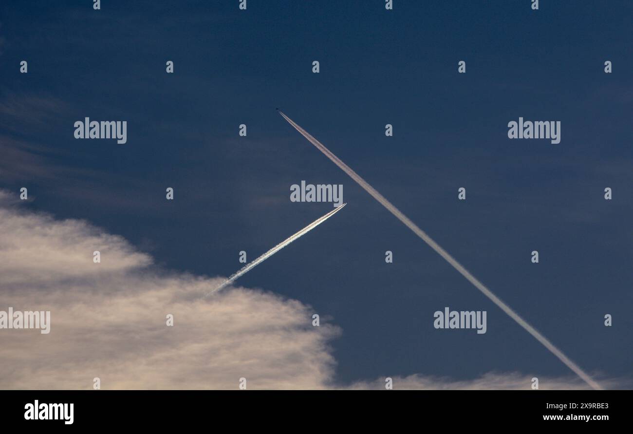 Two commercial passenger jets cross paths as they fly high over North ...