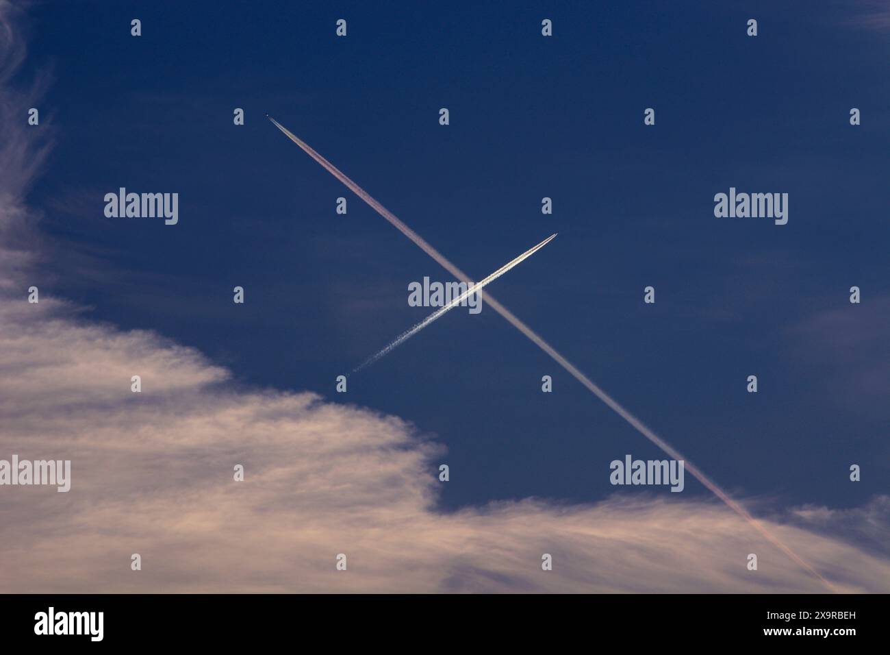 Two commercial passenger jets cross paths as they fly high over North ...