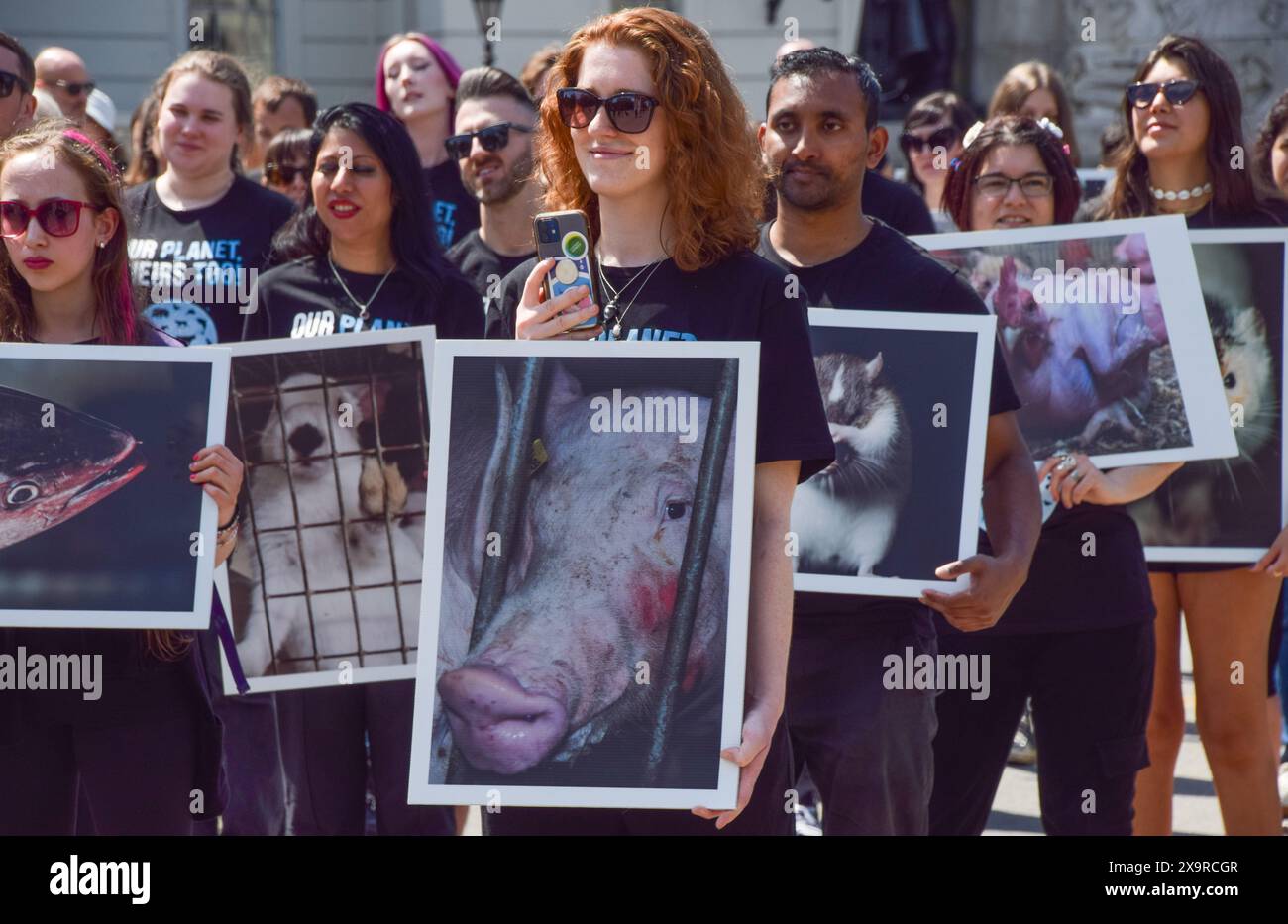 London, UK. 02nd June, 2024. Protesters hold photographs of animals ...