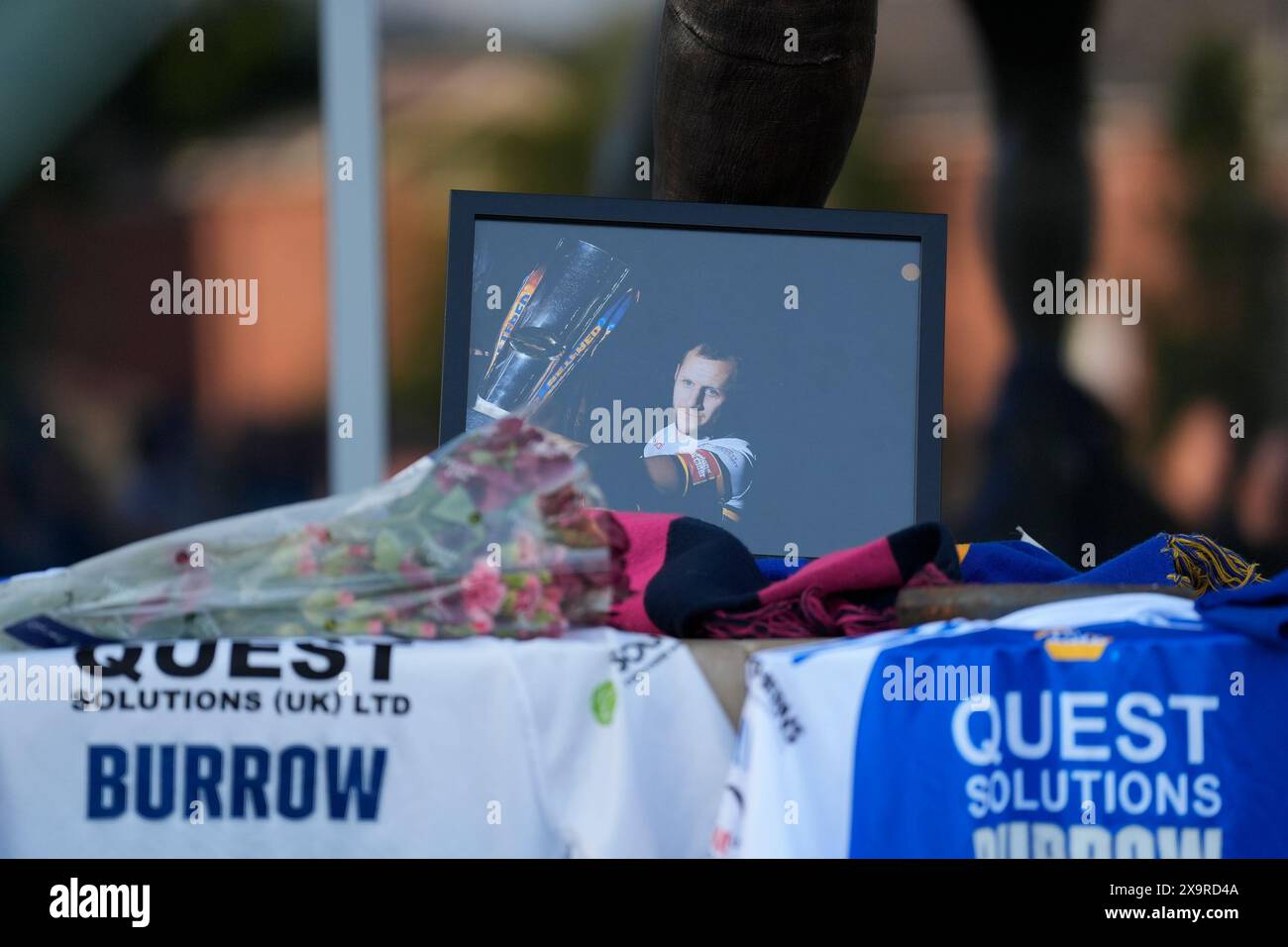 Flowers and shirts left in front of a photograph of former leeds rhino ...