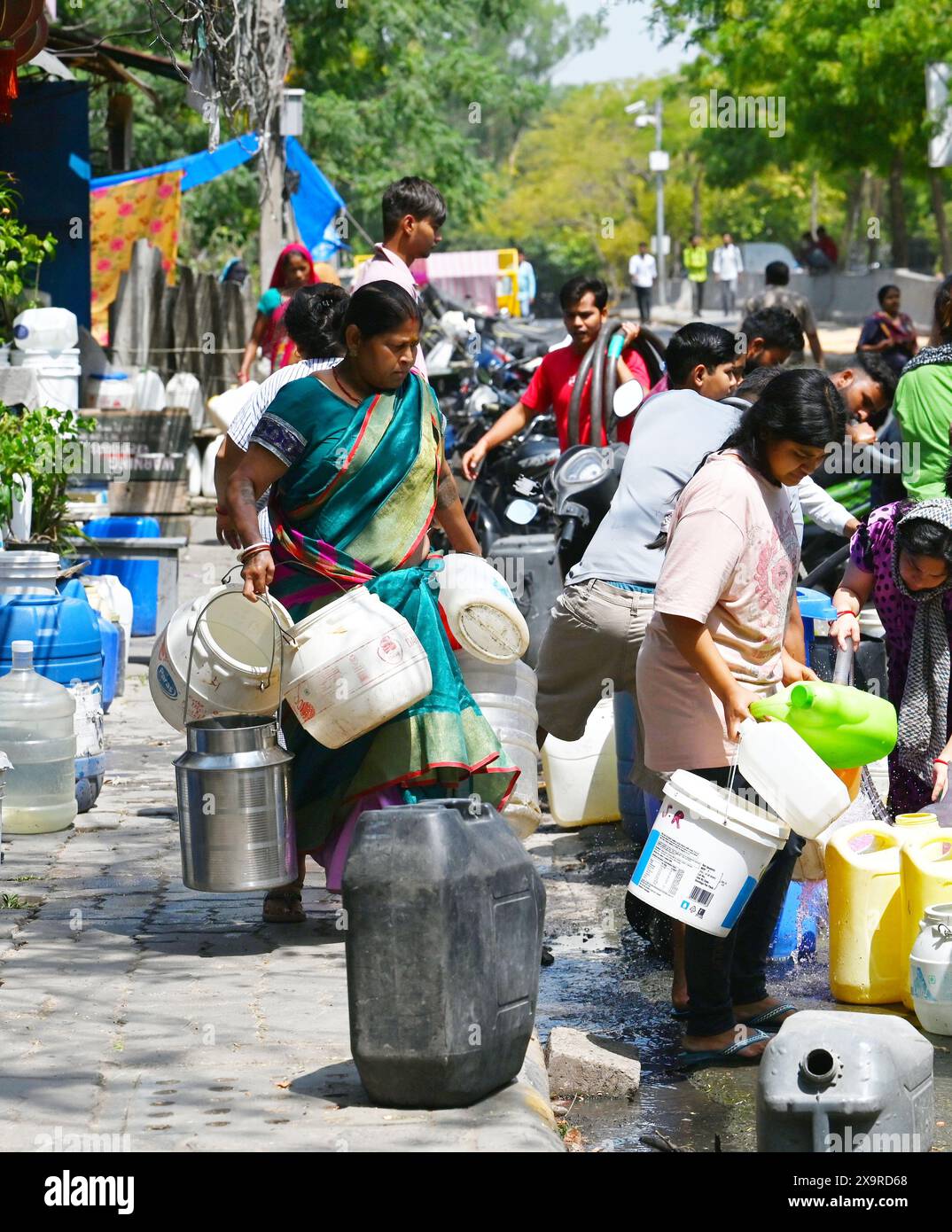 NEW DELHI, INDIA - JUNE 2: Residents of a JJ Cluster get drinking water ...