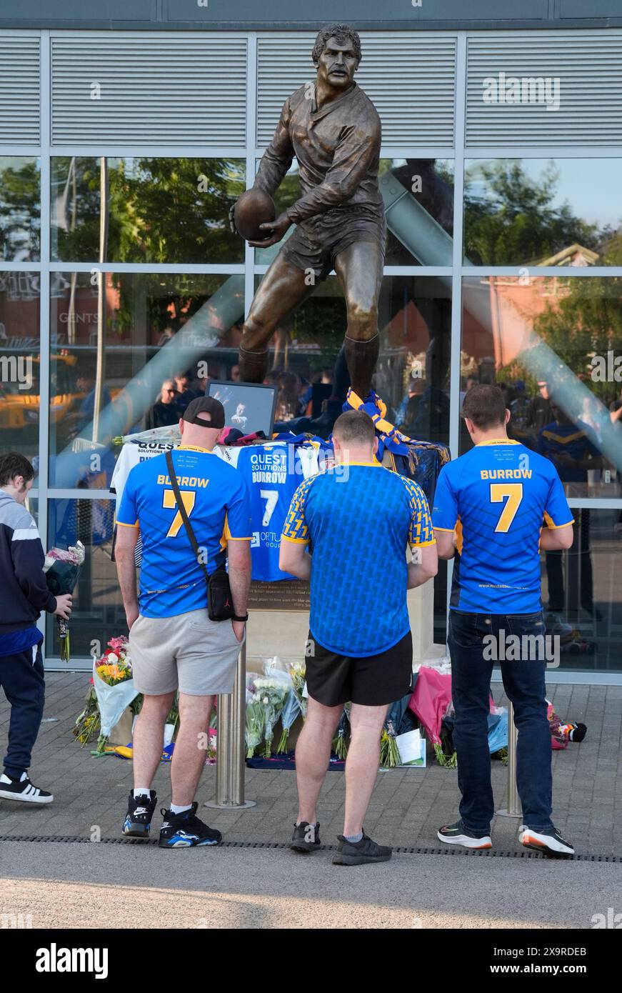 Fans look at flowers and shirts left outside Headingley Stadium in ...