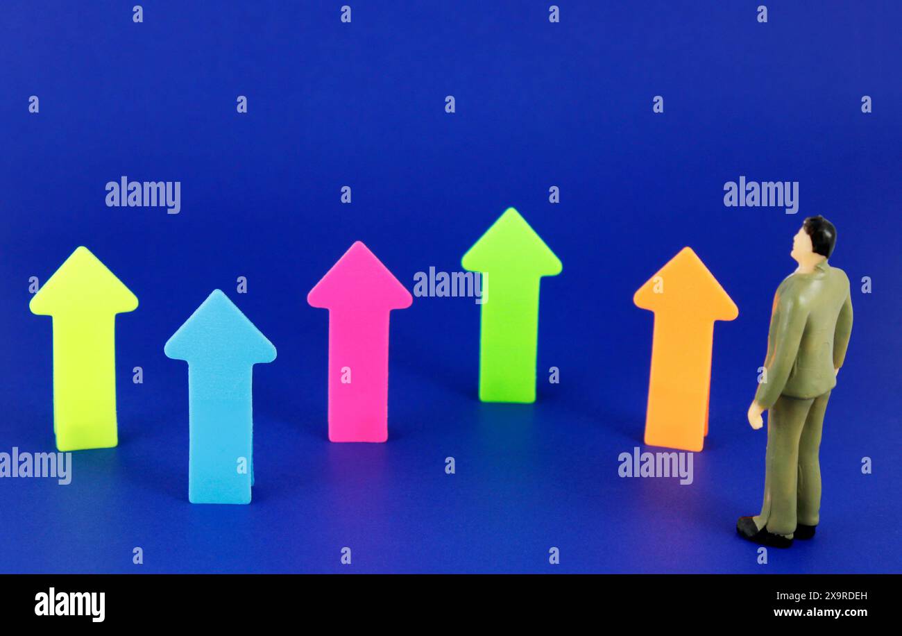 Executive in front of arrows symbolizing different work goals Stock ...