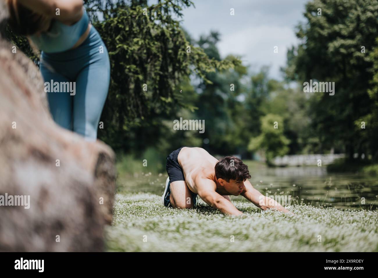 Young athletes doing outdoor warm up and calisthenics exercise routine ...