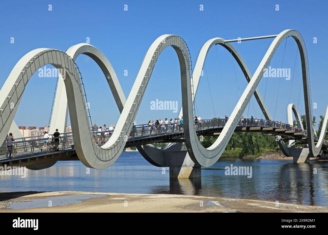 Kiev, Ukraine - May 25, 2024: Modern artistic wave shaped bridge over ...