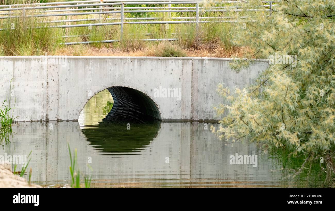 Rural water stream flows under a cement bridge Stock Photo - Alamy