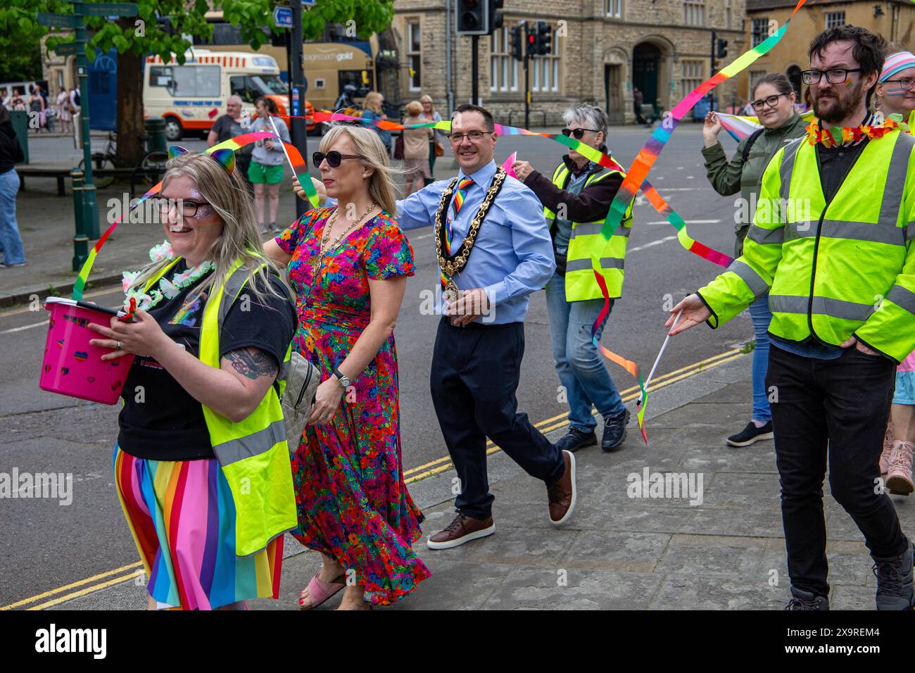 People celebrating at an outdoor event with colorful attire and ...