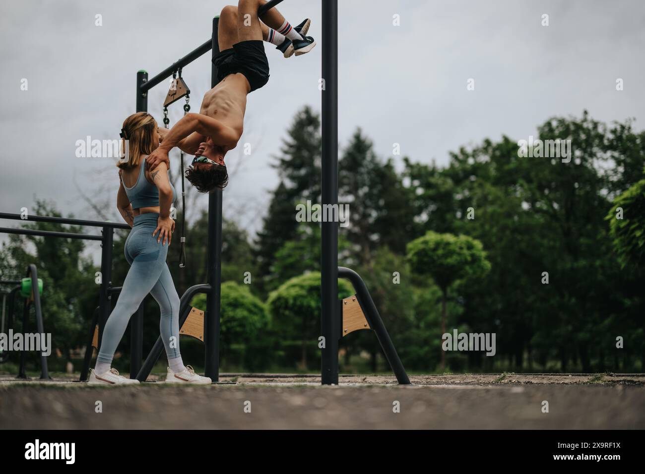 Outdoor calisthenics workout with a man and woman at park fitness ...