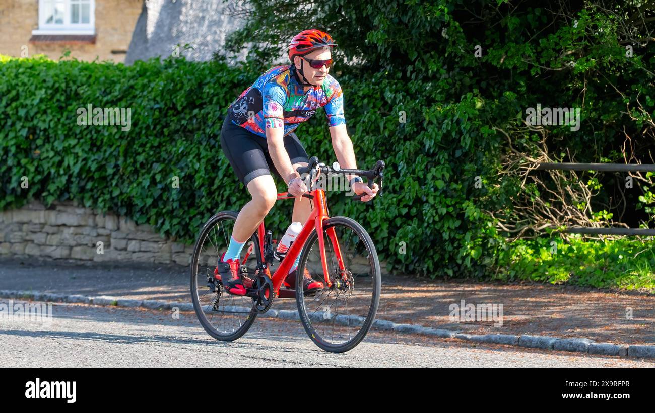 Stoke Goldington,UK - May 11th 2024: Cyclist wearing skin tight lycra ...