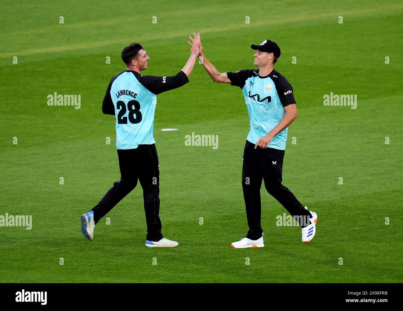 Surrey's Spencer Johnson (right) celebrates with team-mate Dan Lawrence ...