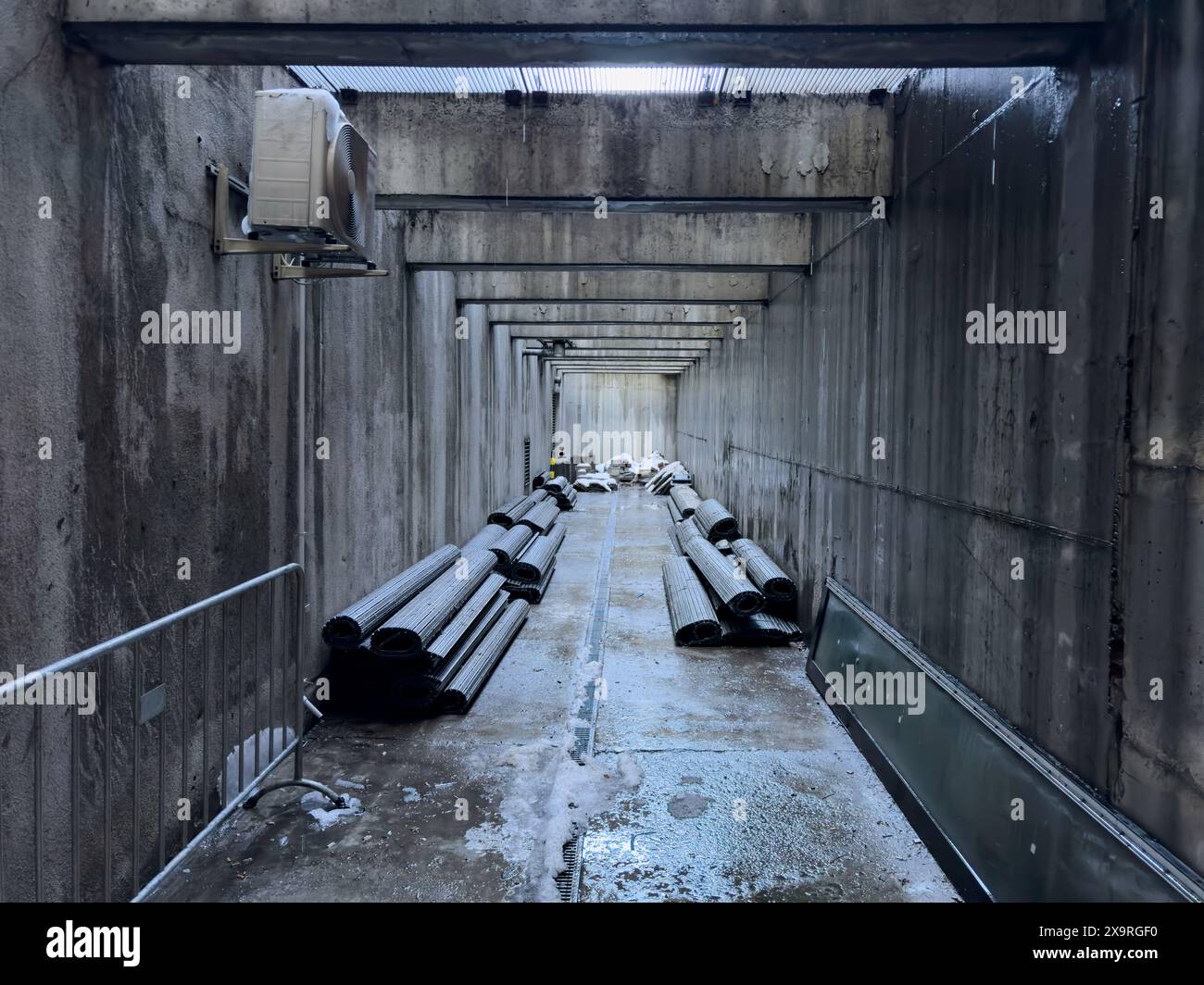 Concrete long rectangular tunnel with storage of building materials ...