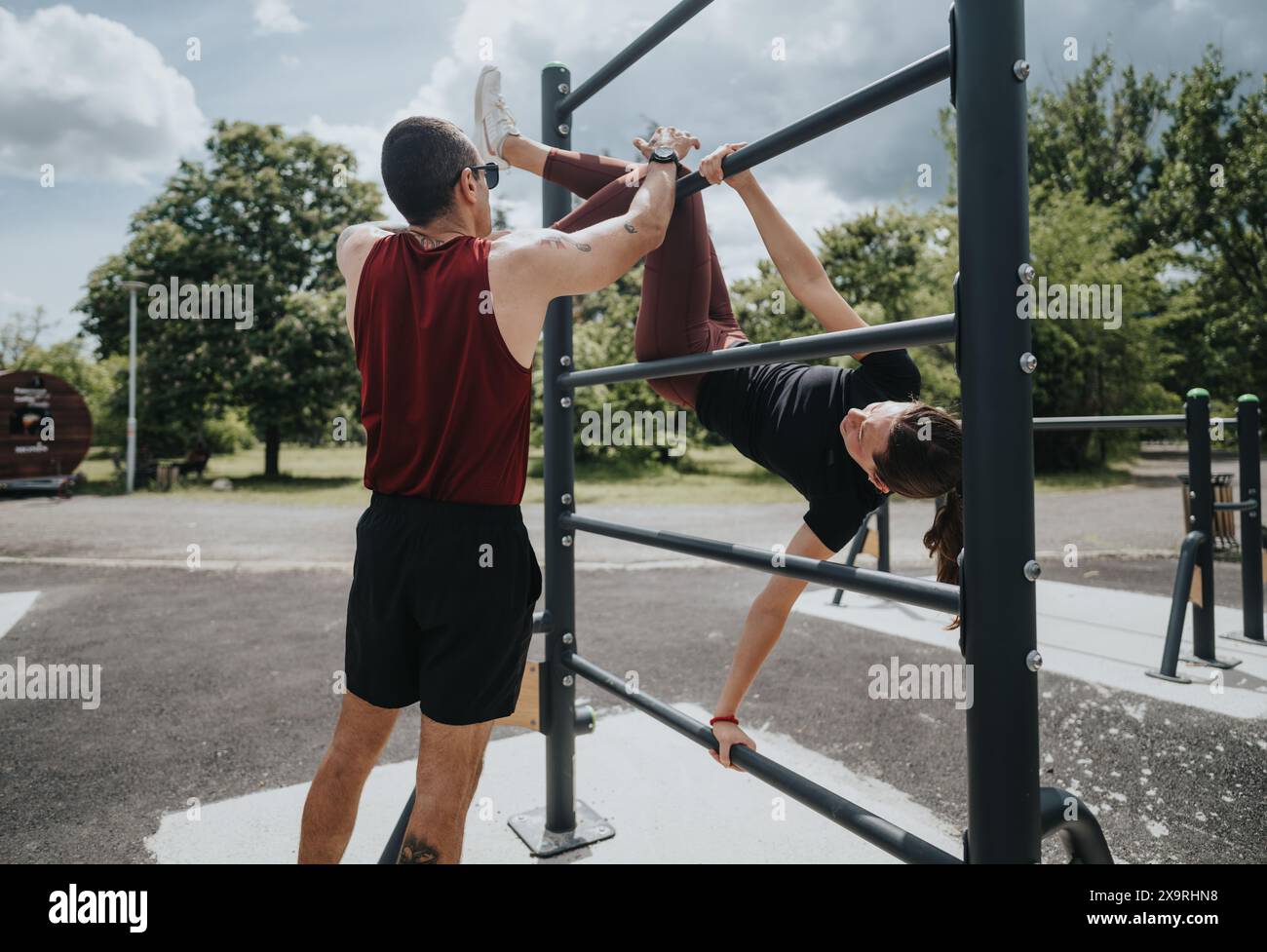 Fitness enthusiasts training together at an outdoor gym, showcasing ...