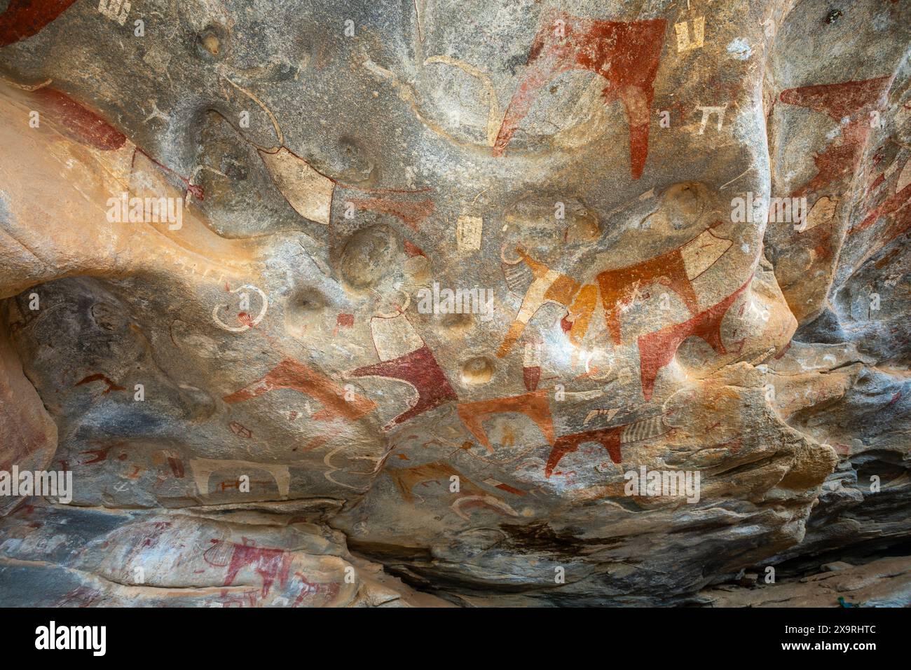 Ancient tribal rock artwork primitive carvings of cattle and hunters ...