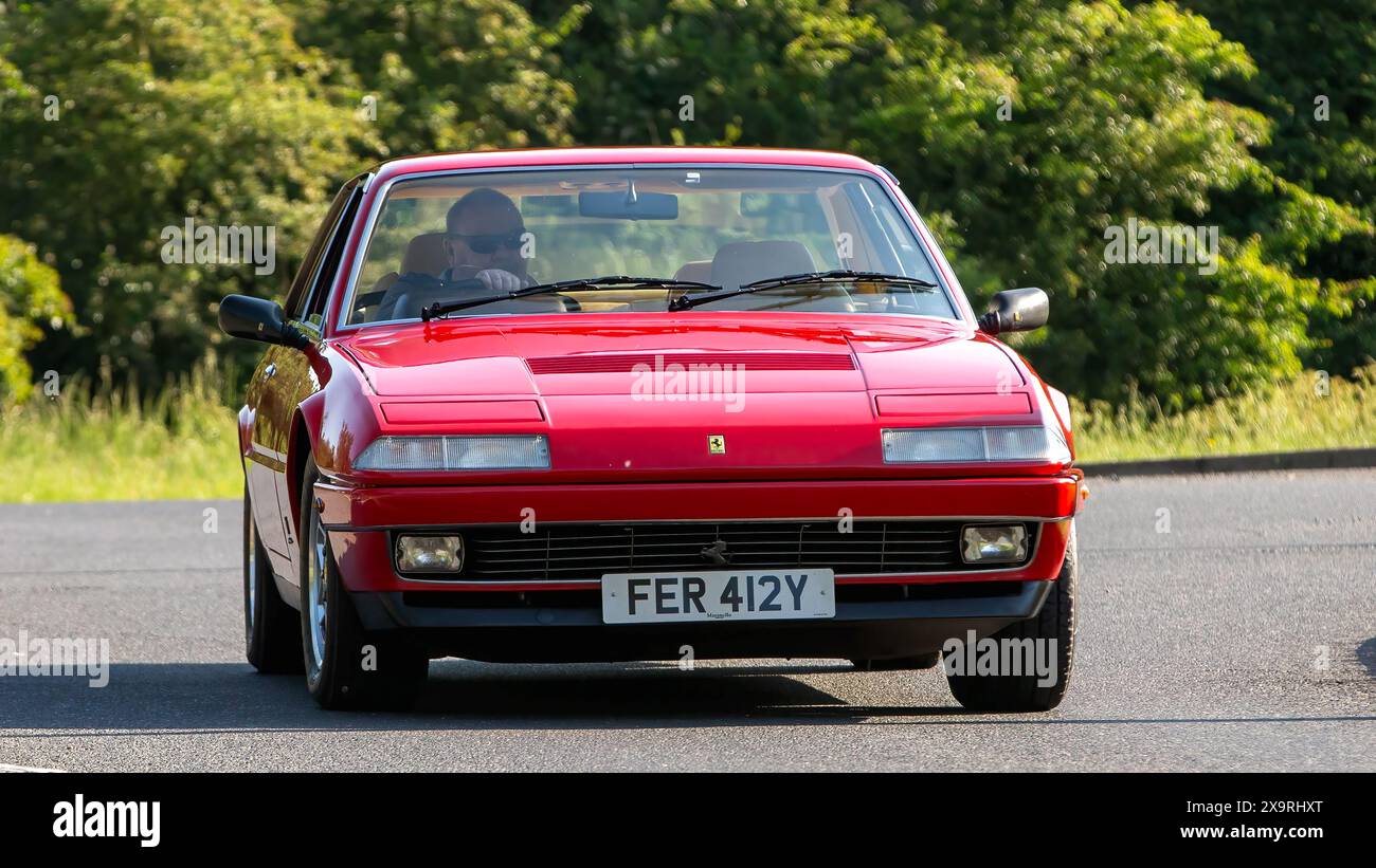Stony Stratford,UK - June 2nd 2024: 1989 red Ferrari 412 car driving on ...