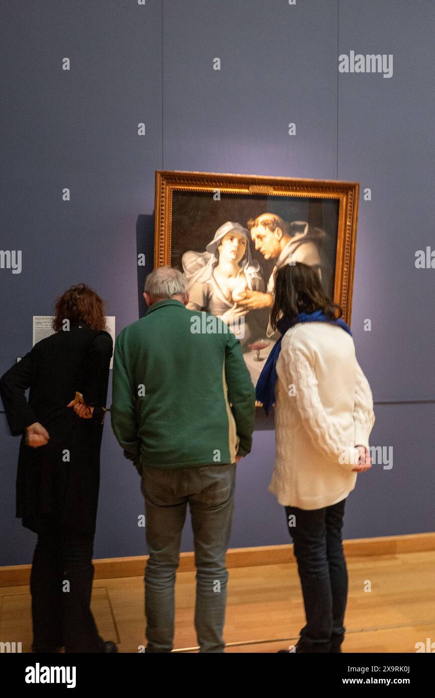 visitors looking at 'a monk and a beguine', painting of Cornelis Cornelisz van Haarlem in museum ...