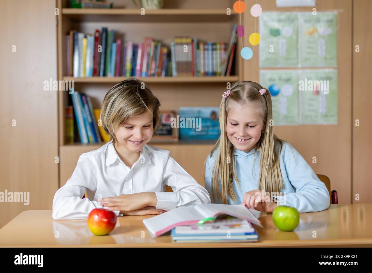 Portrait of two cute caucasian young blond little classmate friend kids ...