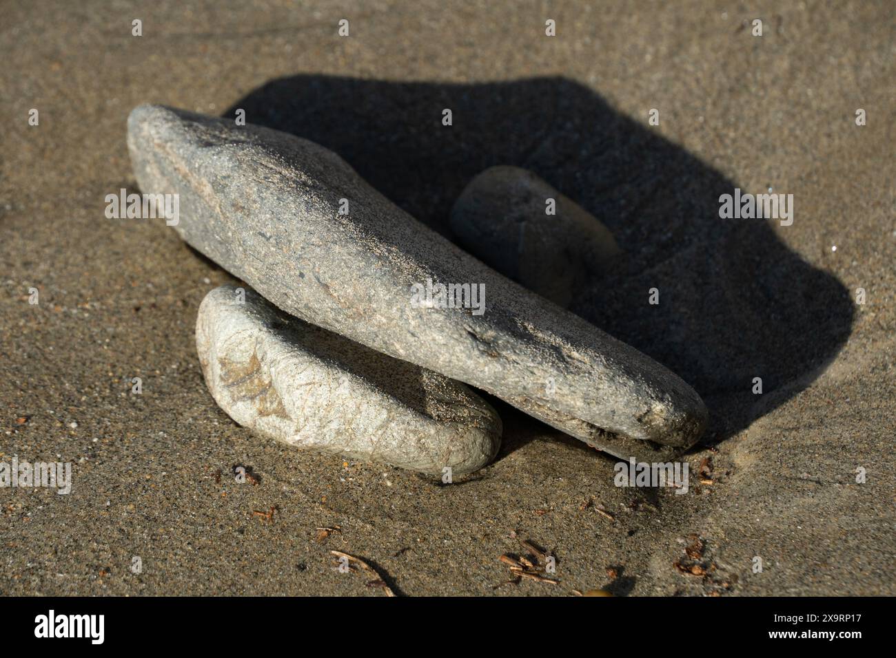 Smooth rocks on sand with shadow. Minimalist nature concept Stock Photo ...