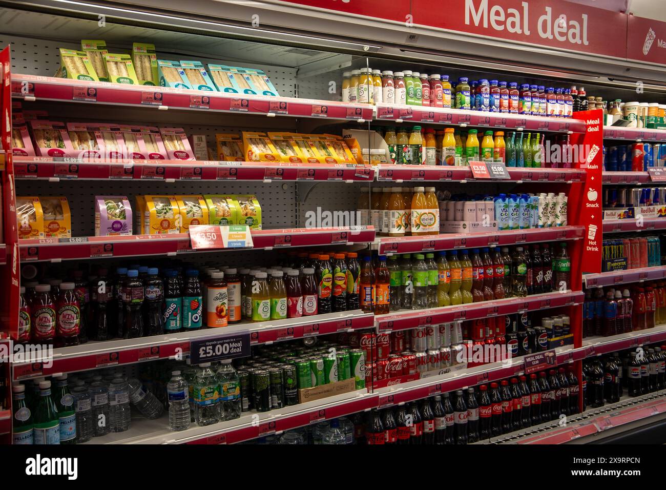 Full shelves of various beverages and juices in a supermarket with ...