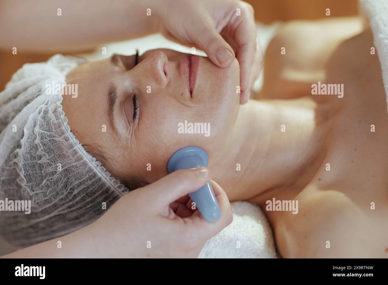 Healthcare time. medical massage therapist in massage cabinet with silicone massage cup ...