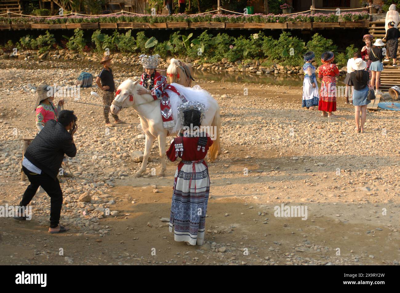 Tourist dressed up in Hilltribe traditional attire sat om a horse, Cat ...