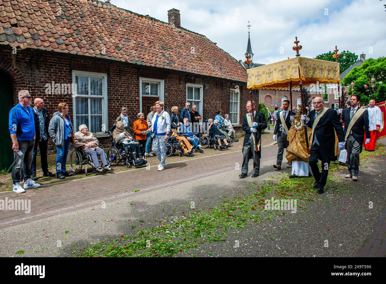 A group of old people watches the procession passing by during the ...
