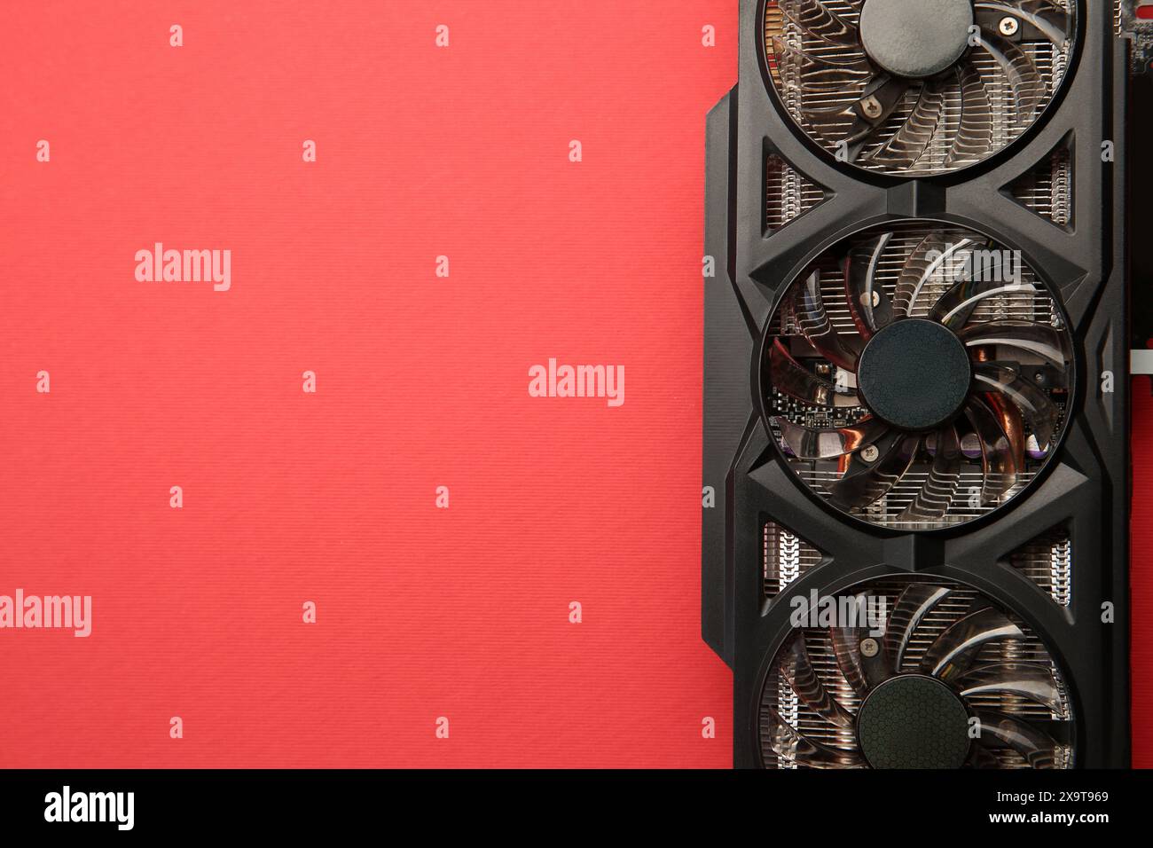 One graphics card on red background, top view. Space for text Stock ...