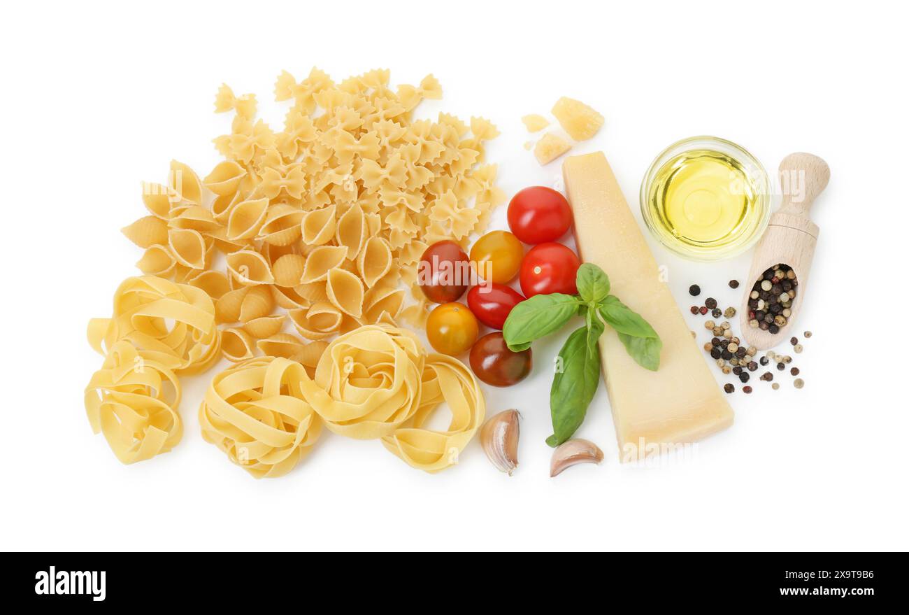 Different types of pasta and ingredients on white background, top view ...