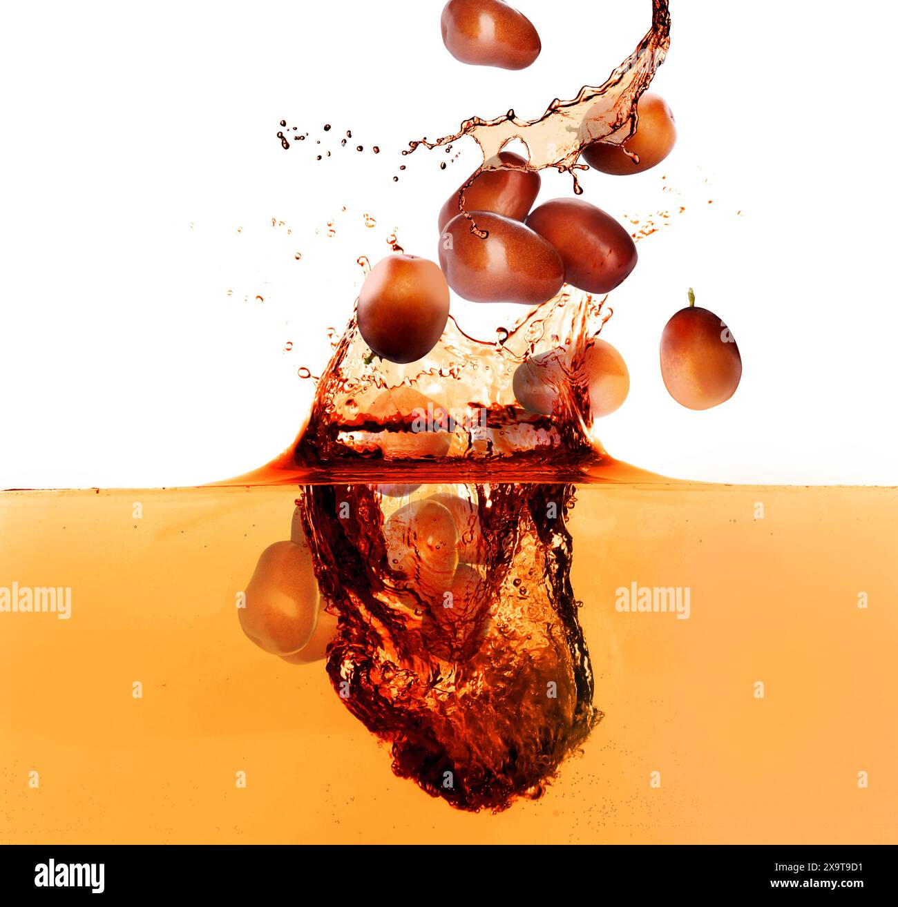 Palm fruits falling into cooking oil on white background Stock Photo ...