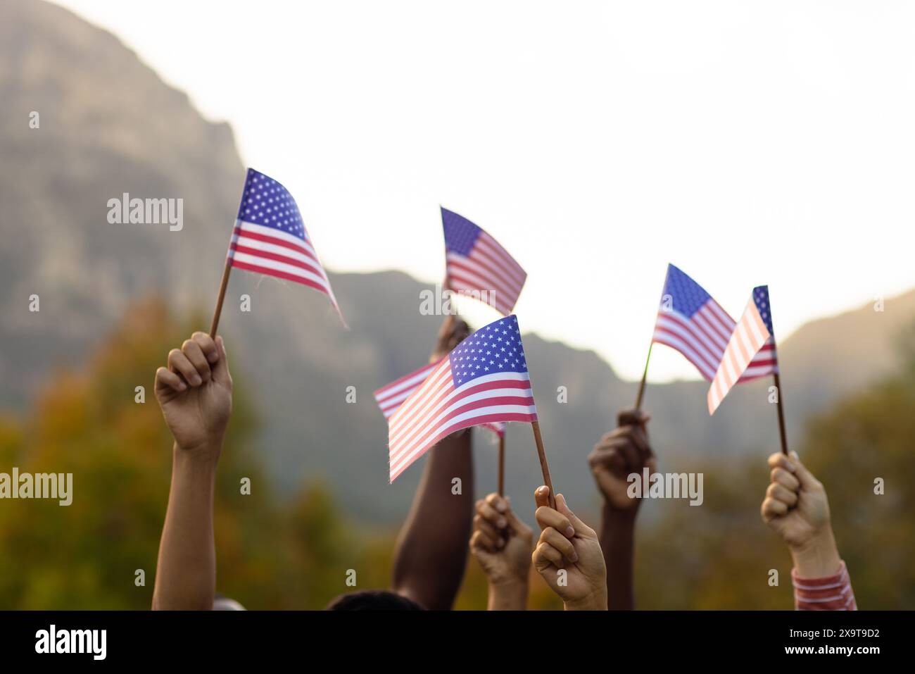 Diverse friends raising hands with flags of usa in garden Stock Photo ...