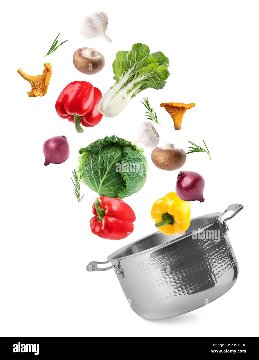 Fresh ingredients falling into saucepan on white background Stock Photo ...