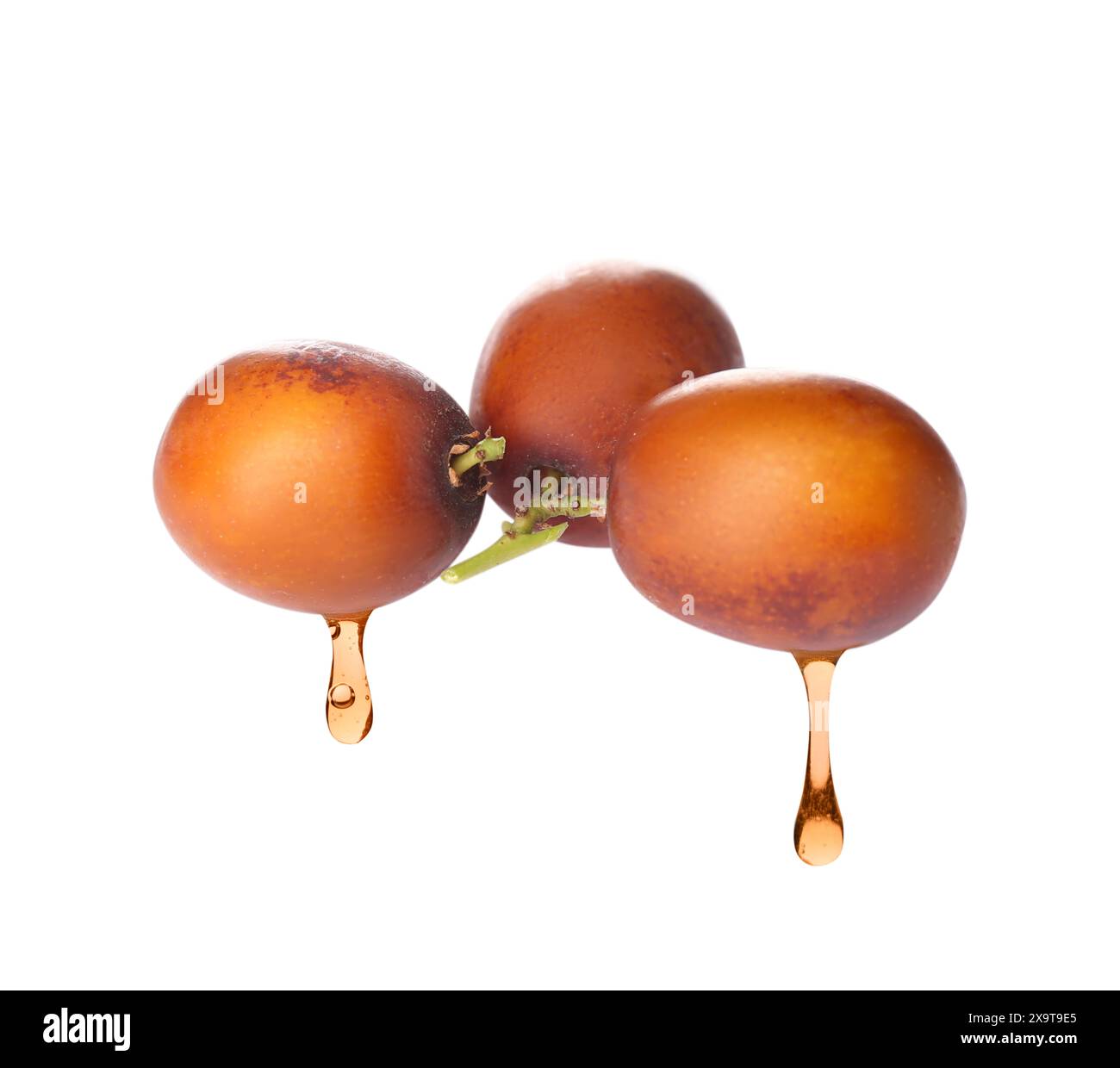 Oil dripping from palm fruits on white background Stock Photo - Alamy