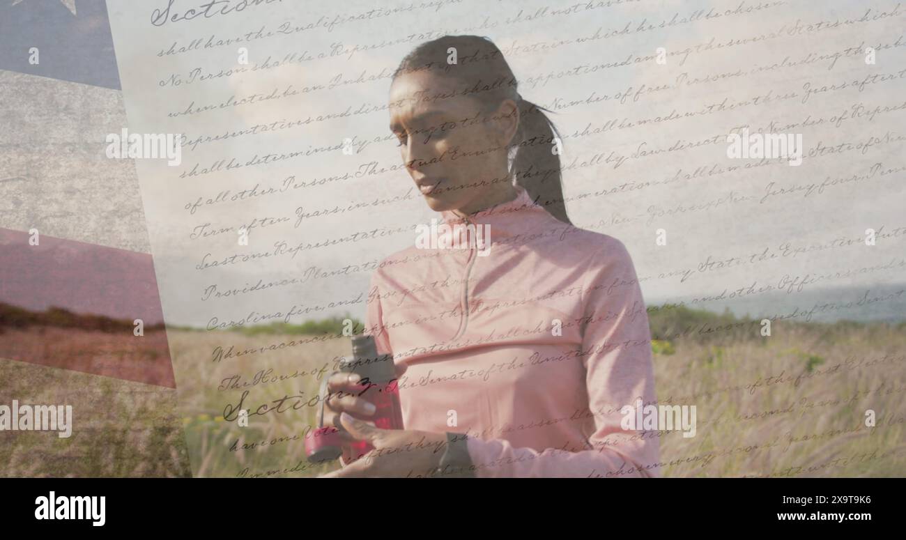 Image of american flag over biracial woman drinking water in mountains ...