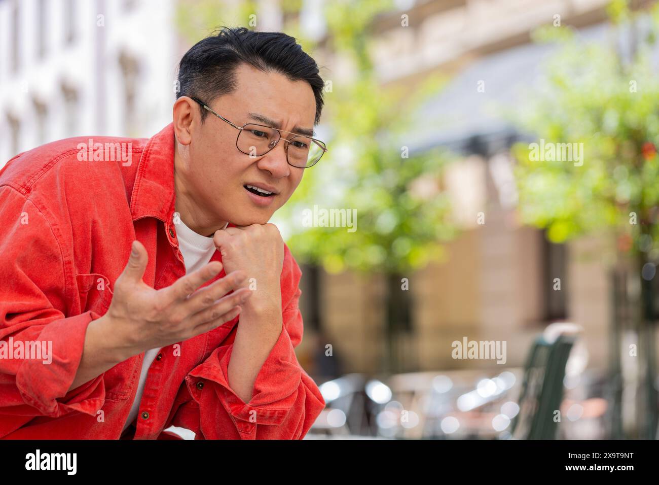 Sad unhappy Asian middle-aged man suffers from unfair situation ...