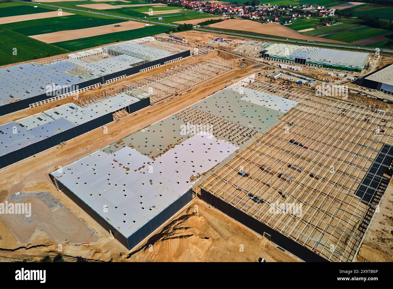 Aerial view of construction site with warehouse building under ...