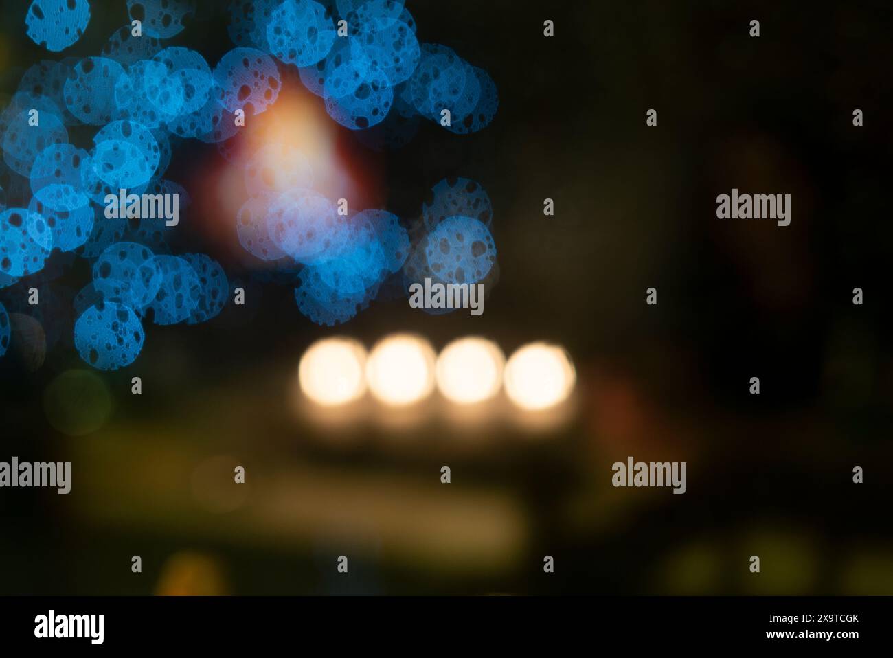 Blurry reflection of circles of blur in a night window. Beautiful bokeh ...