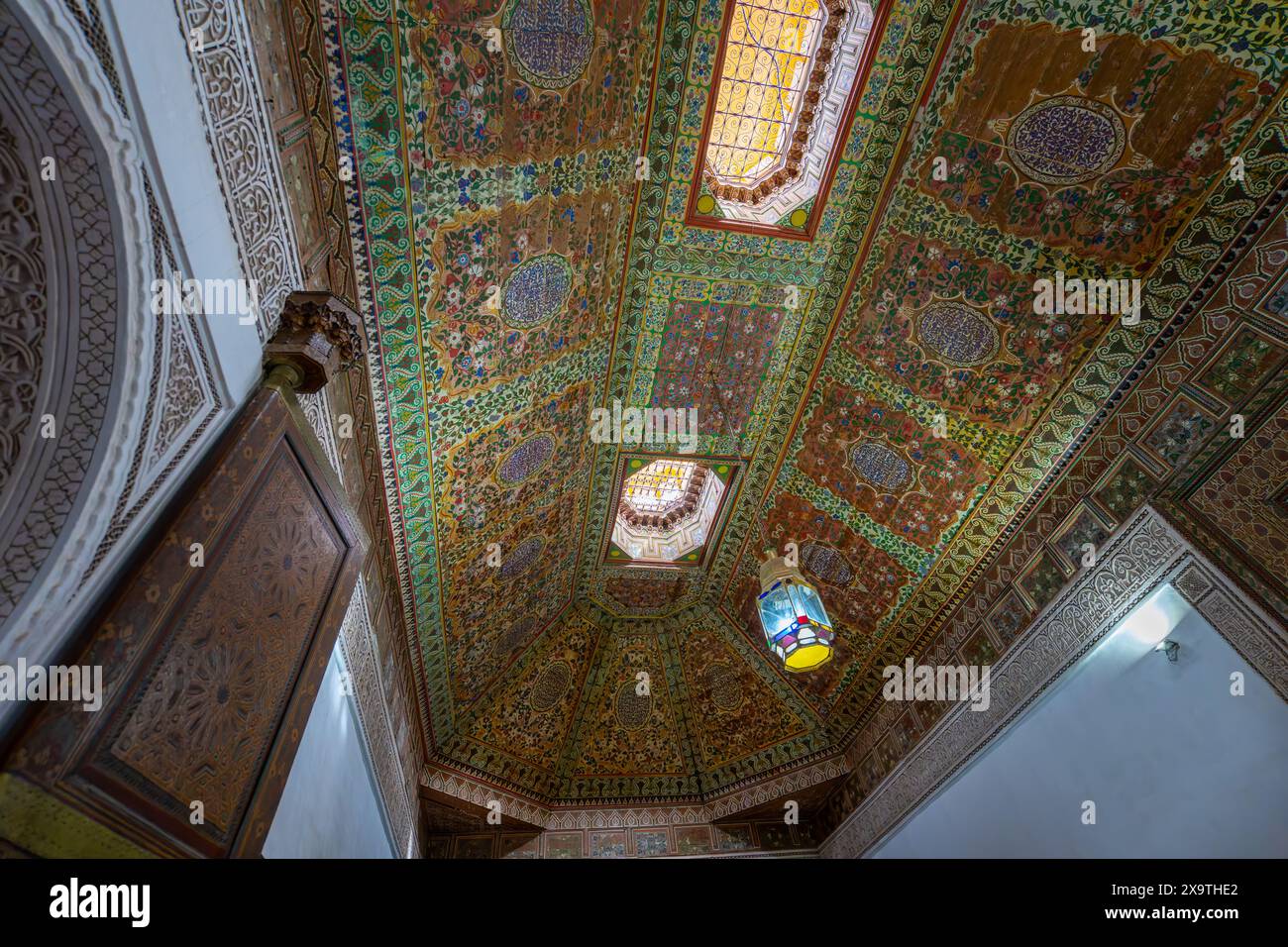 Bahia Palace, Marrakech, Morocco - March 18, 2024: Vibrant mosaic ceilings and stained glass ...