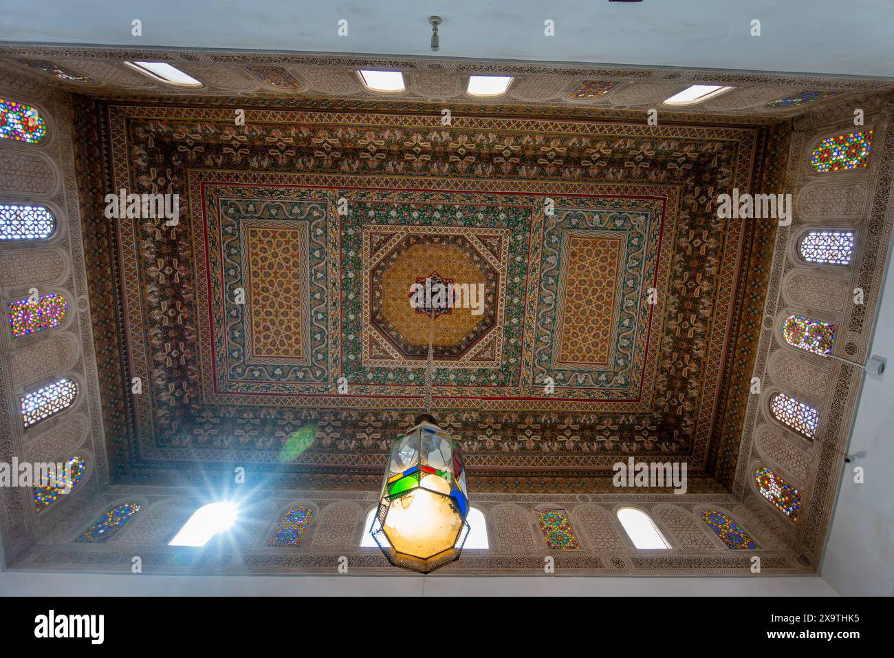 Bahia Palace, Marrakech, Morocco - March 18, 2024: Vibrant mosaic ceilings and stained glass ...