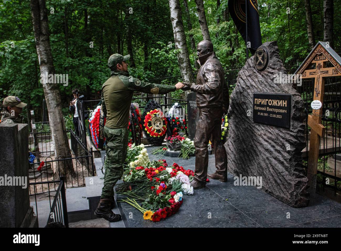 A Wagner PMC fighter touches a sculpture of Yevgeny Prigozhin installed ...