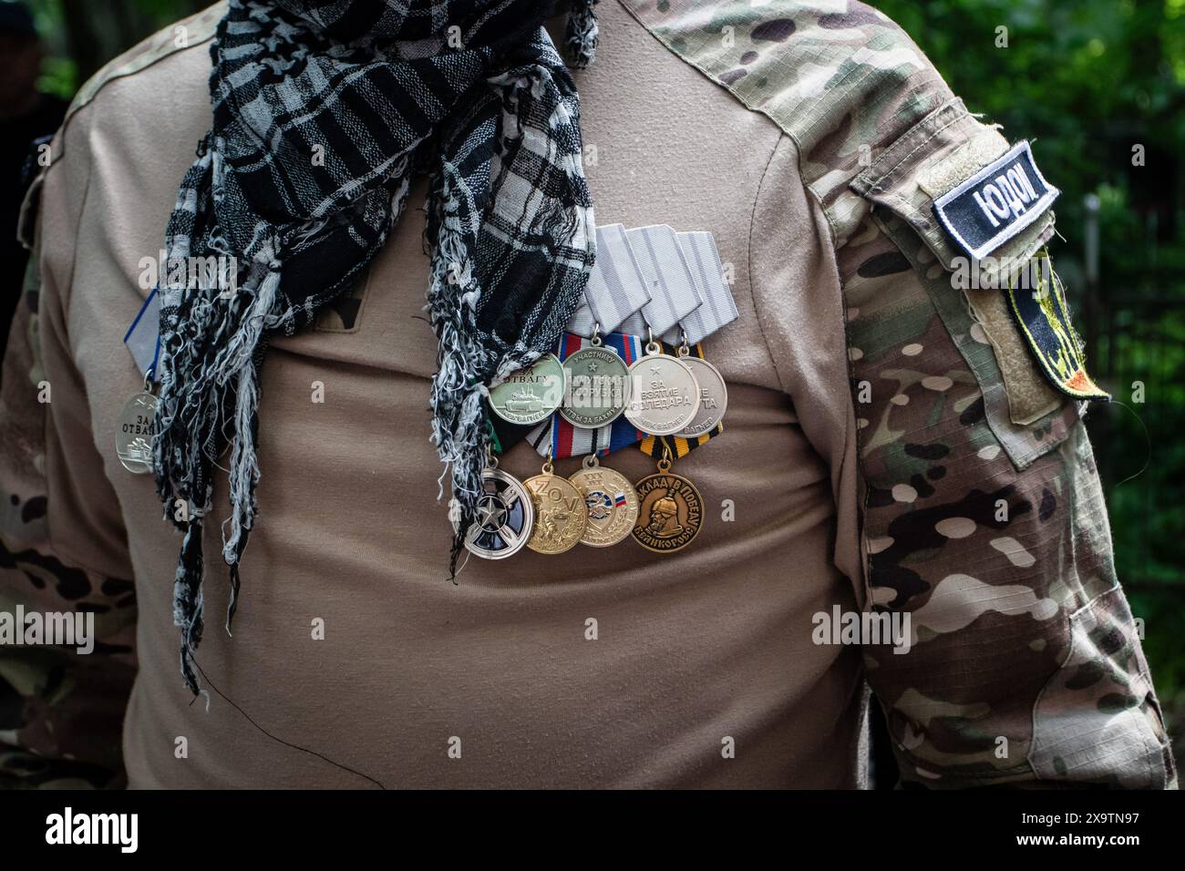 A Wagner PMC fighter with medals for courage stands is seen at the ...