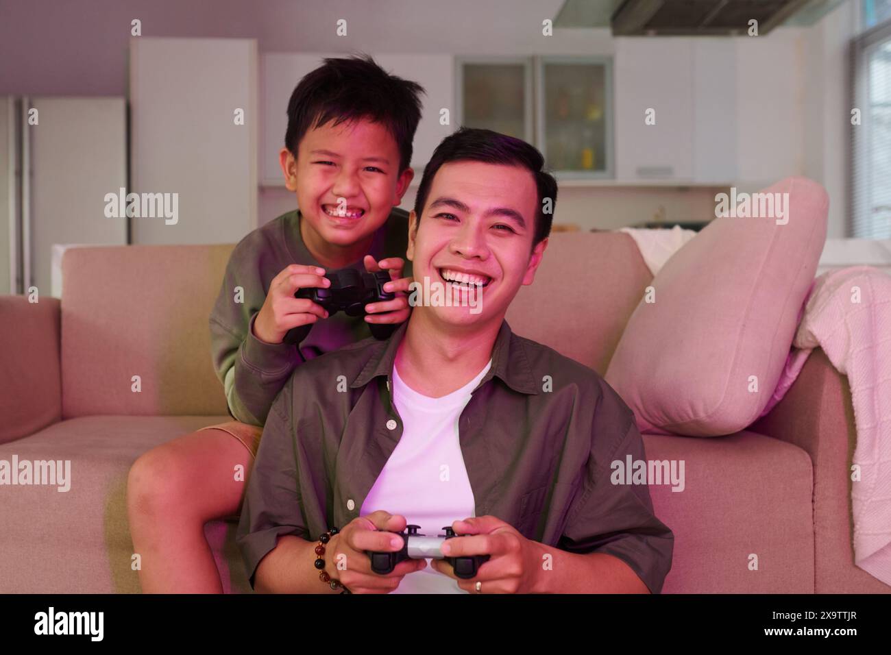 Excited father son playing videogame hi-res stock photography and ...