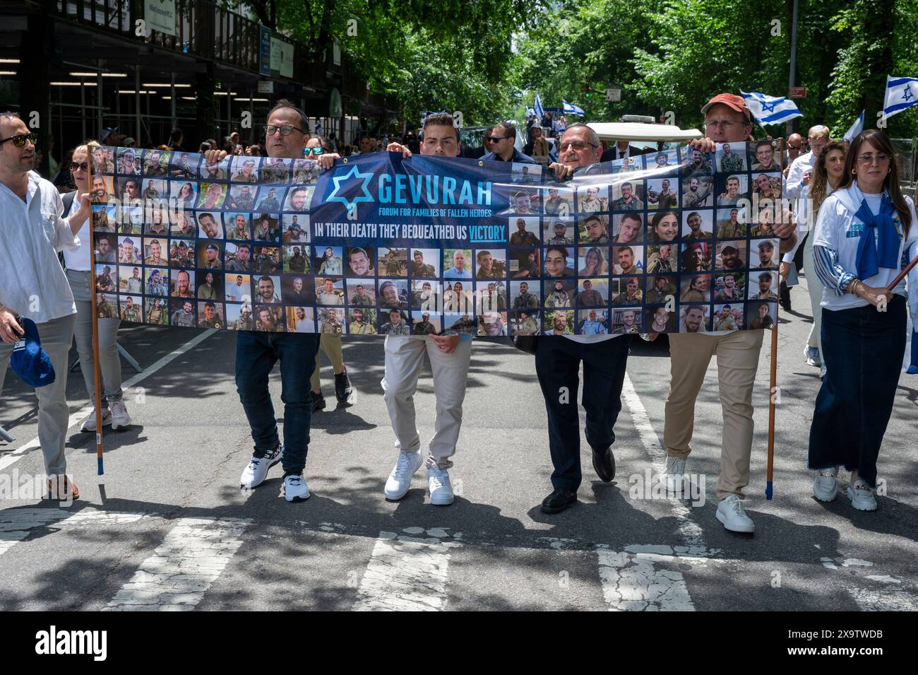 NEW YORK, NEW YORK - JUNE 02: People holding a baner with pictures of ...