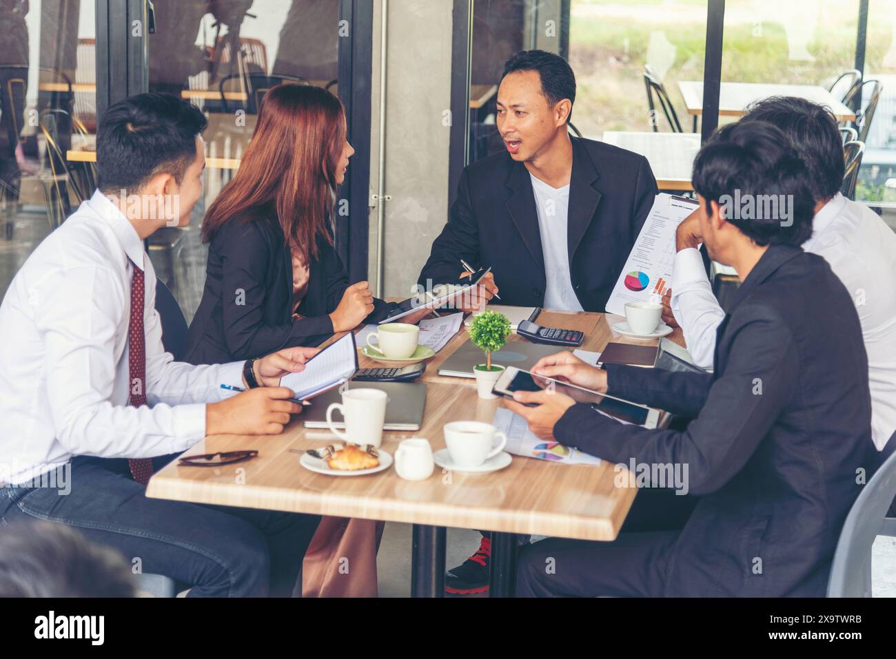Business partner team meeting working together on office desk. Group of ...