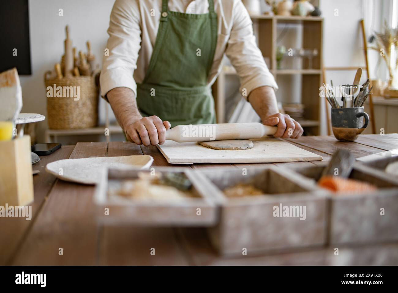 Process of making piece of pottery art in bright studio Stock Photo - Alamy