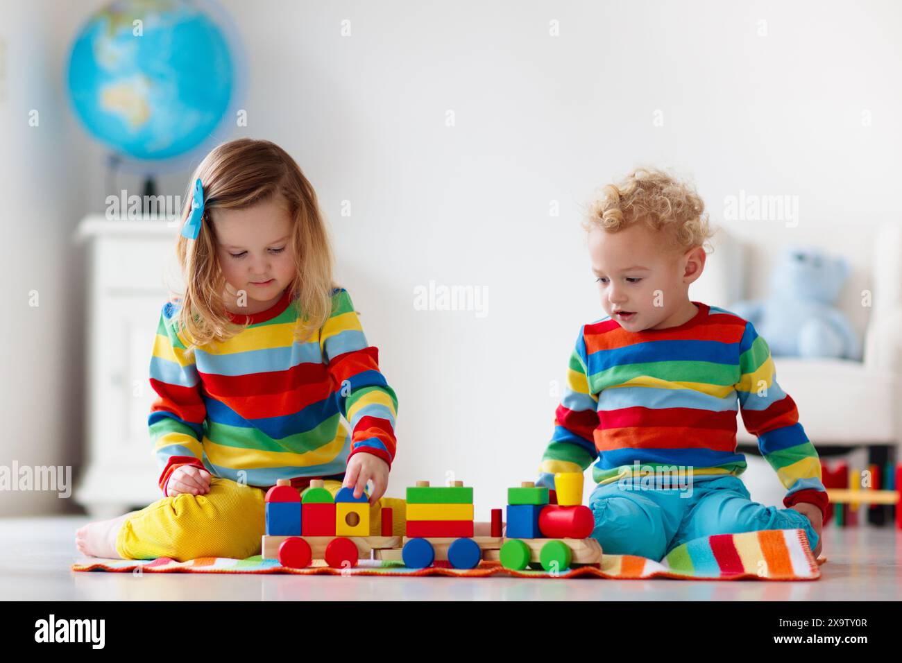 Children playing with wooden train. Toddler kid and baby play with ...