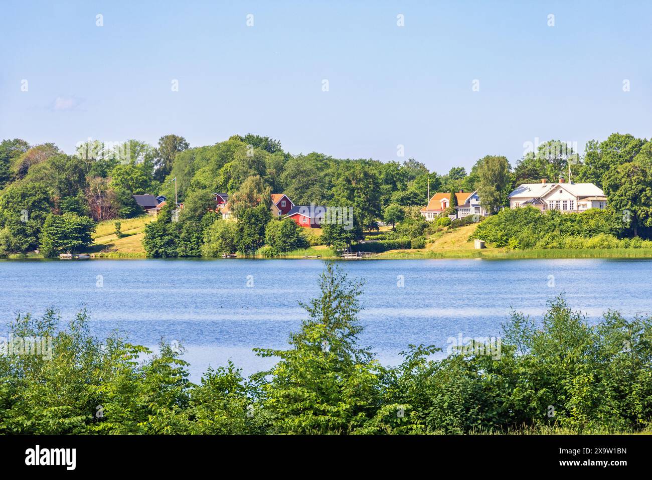 Lake view with residential buildings by the beach in summer Stock Photo ...